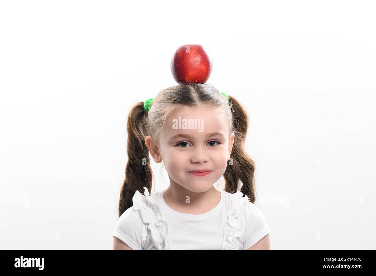 Red apple and little girl, portrait of a child on a white background ...