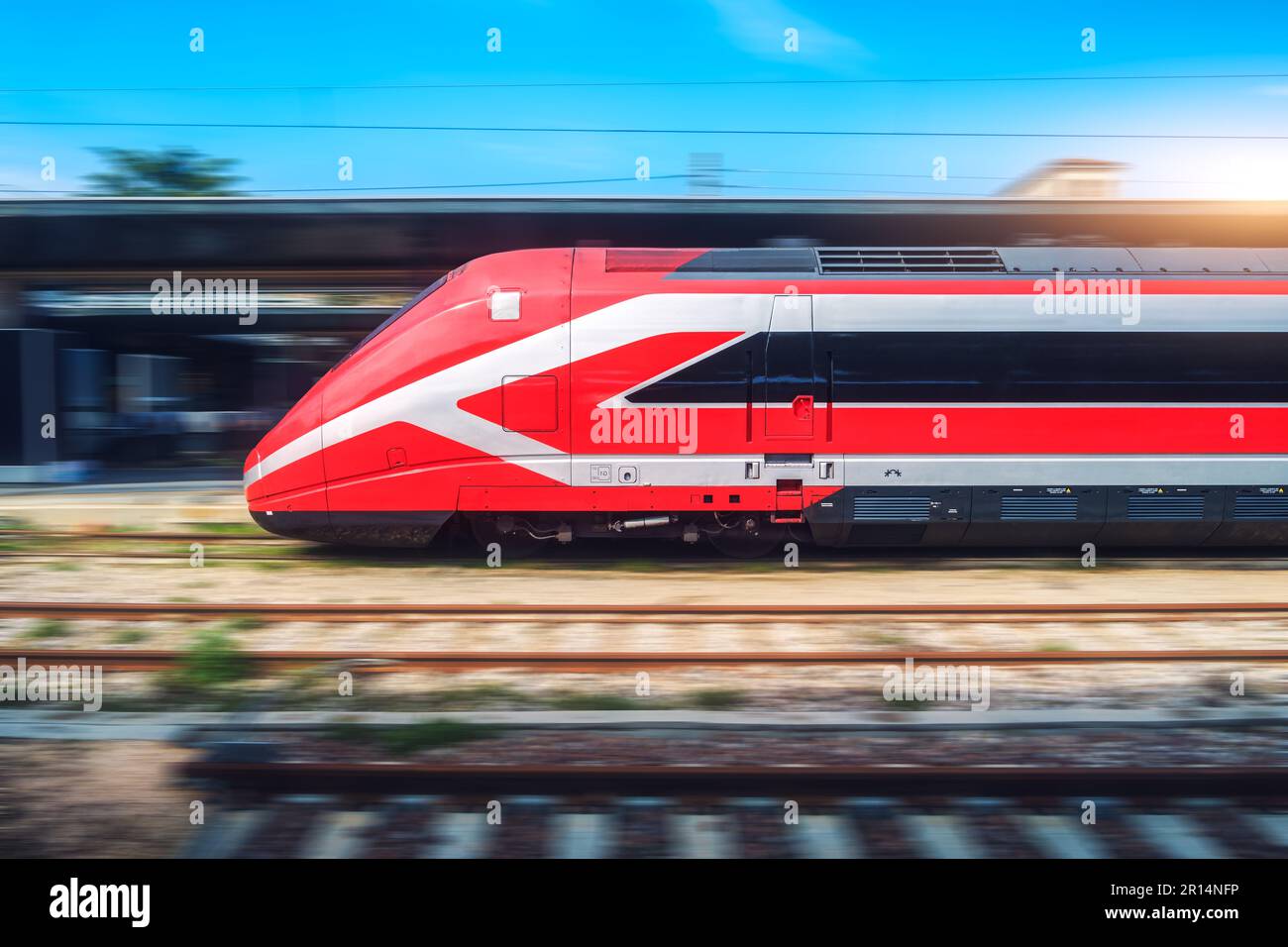 Red high speed train in motion on the railway station Stock Photo - Alamy