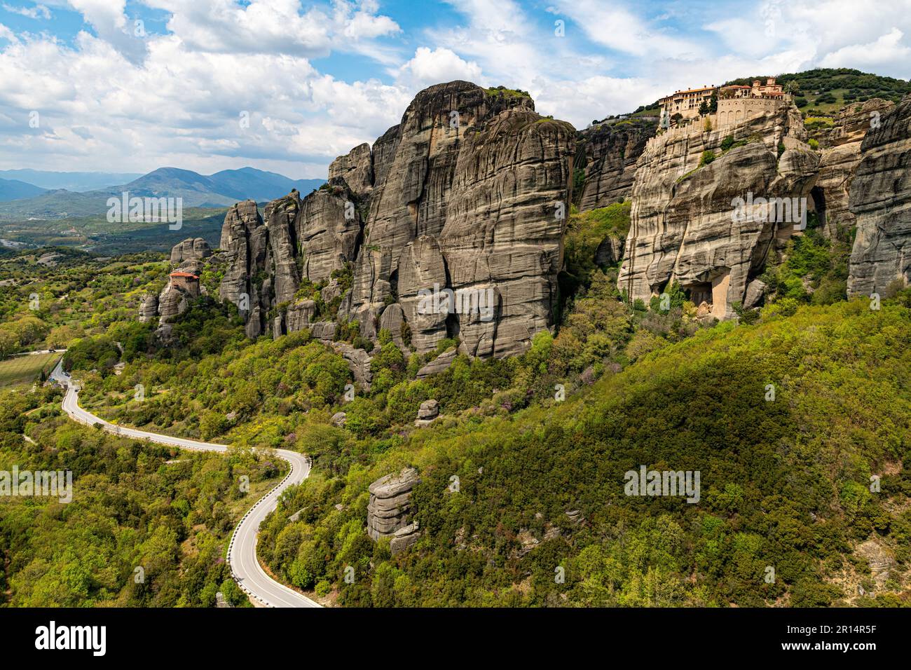 A picturesque landscape of majestic cliffs covered with lush greenery ...