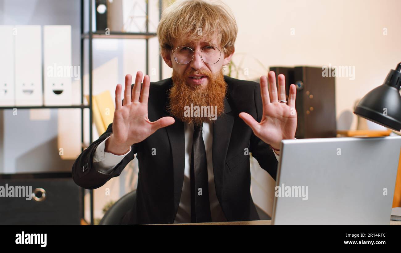 Stop. Young businessman guy working on laptop, warning of finish ...