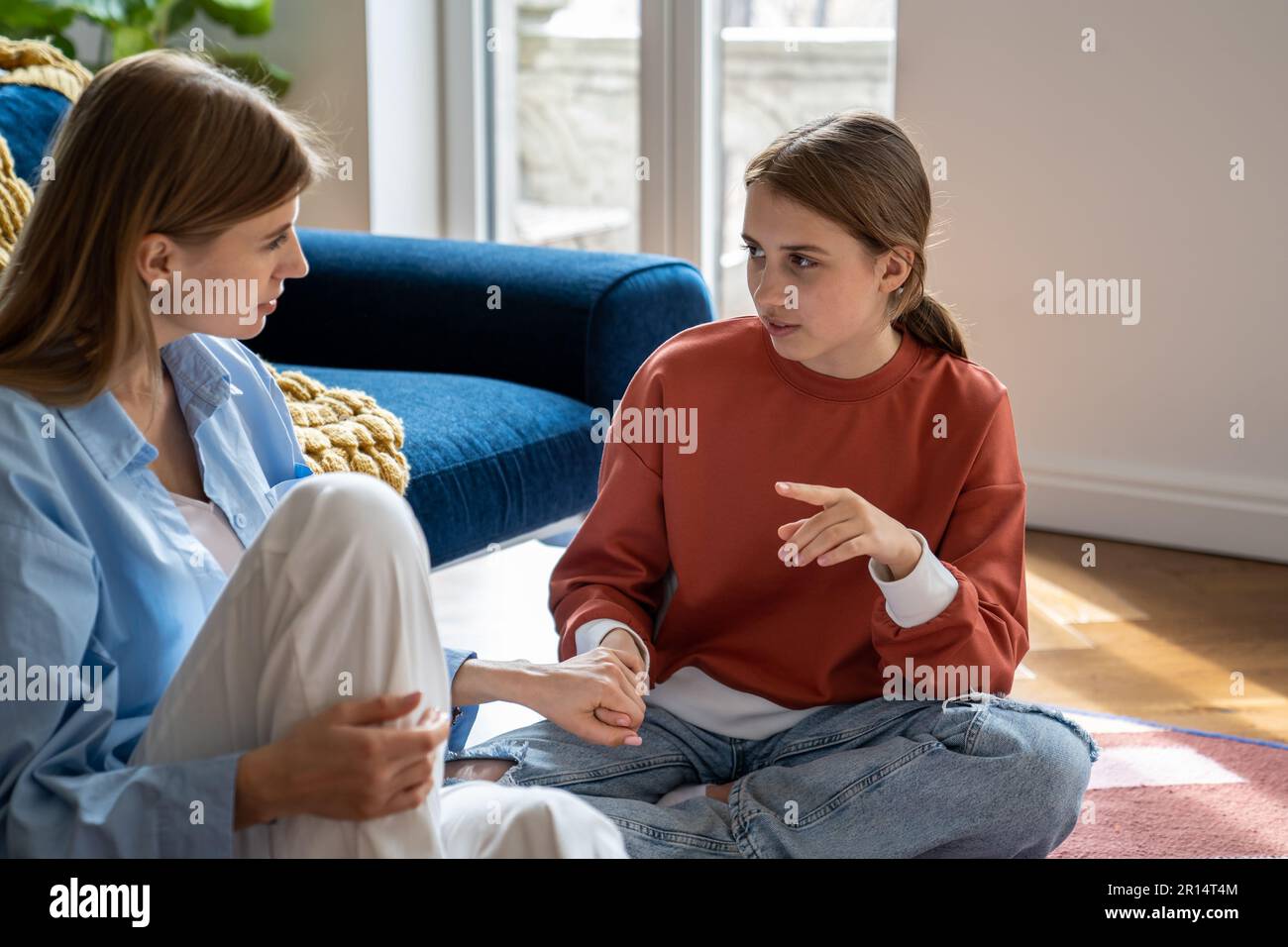 Understanding mother with teen daughter talking and discussing difficulties in relationship ...
