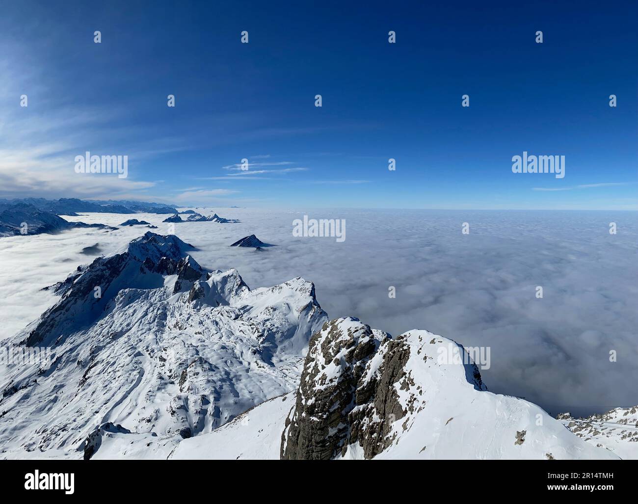 A scenic landscape of mountains draped in a blanket of clouds. Santis ...