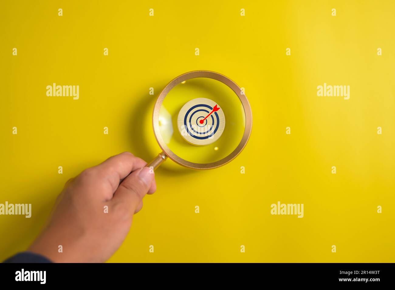 People holding magnifying glass with business goal icon Stock Photo - Alamy