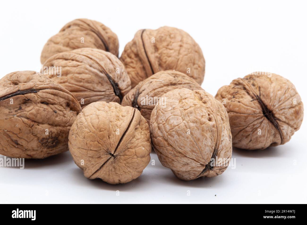 A handful of textured walnuts on a white background. Healthy Food ...