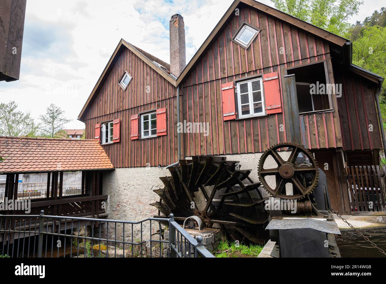 Water wheel and old wooden building of a sawmill in the historic town ...