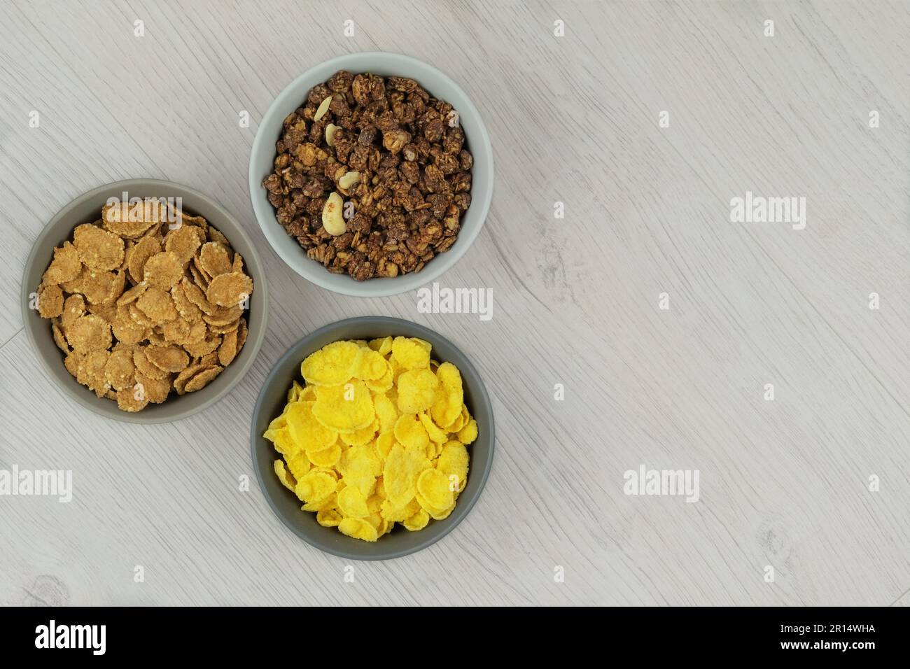 Breakfast cereals in bowls on a light wooden background. Fast food ...