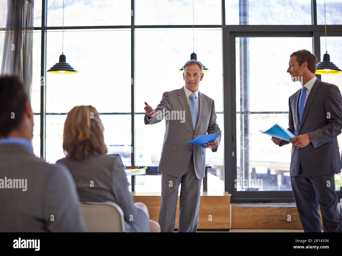 Communicating their ideas to the rest of the team. two businessmen ...