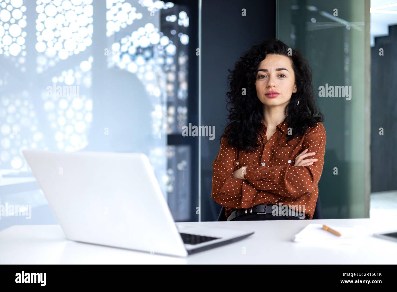 Portrait of serious and confident business woman, hispanic woman ...