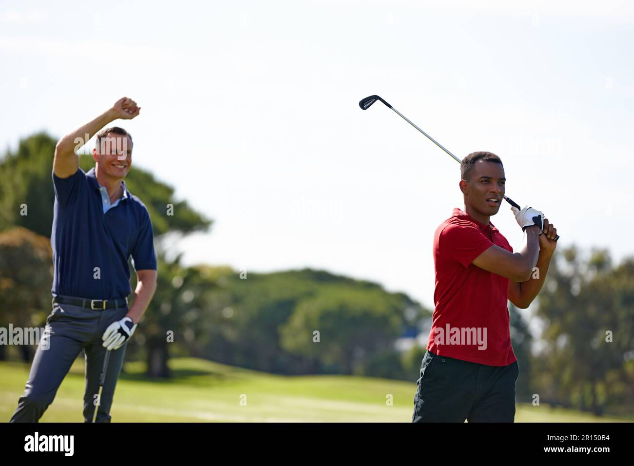 Golf brings them together. two handsome men playing a game of golf ...