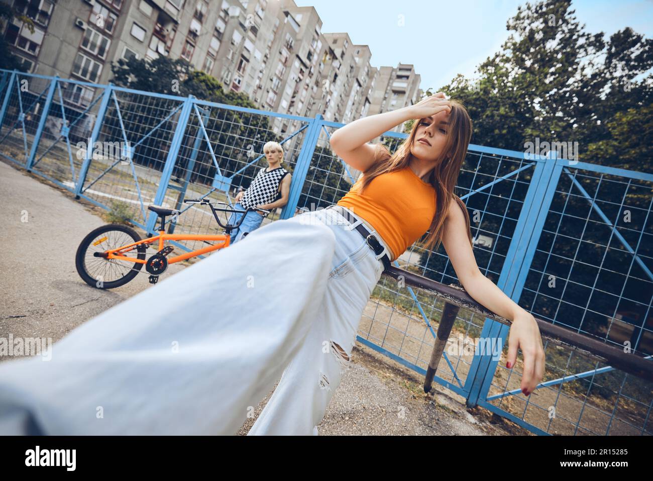 Teenage couple hanging out outside in urban exterior Stock Photo - Alamy