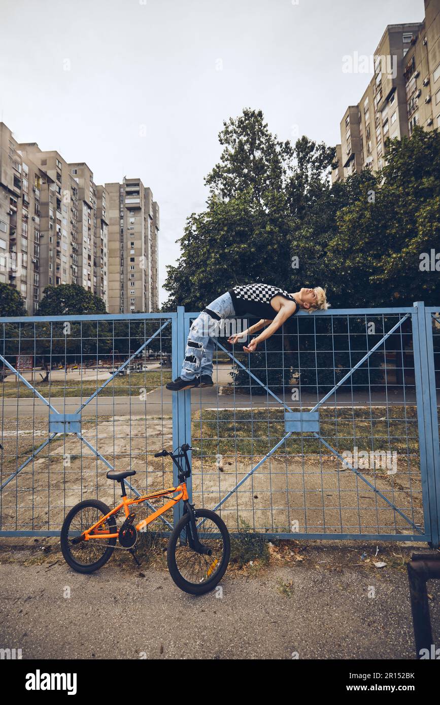 A teenage boy is lying on the fence outside and feeling misunderstood ...