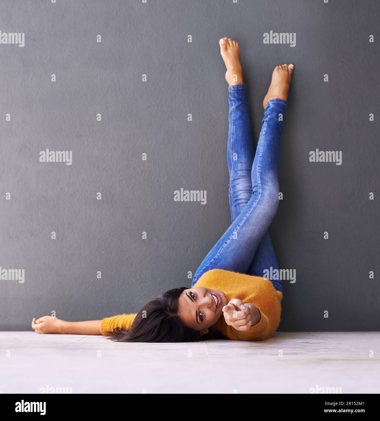 Keep calm and carry on. A young woman pointing at the camera while ...