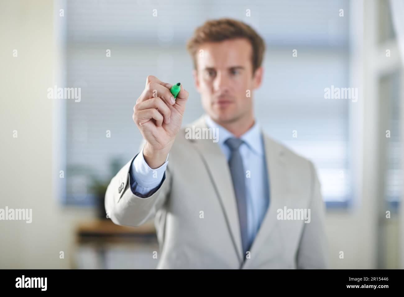 Plotting your business course. a handsome young businessman writing ...