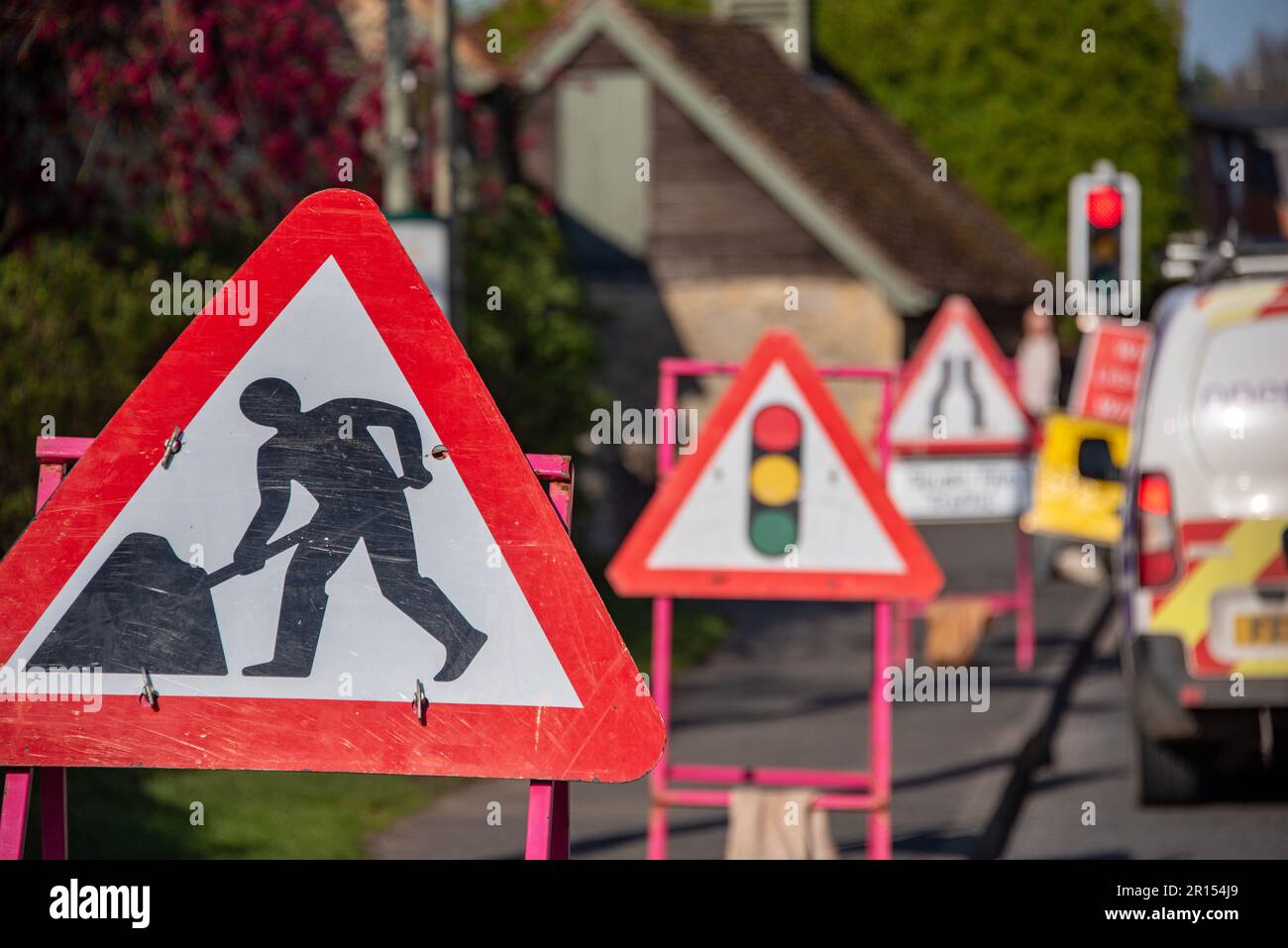 Roadworks signs and temporary traffic lights Stock Photo - Alamy