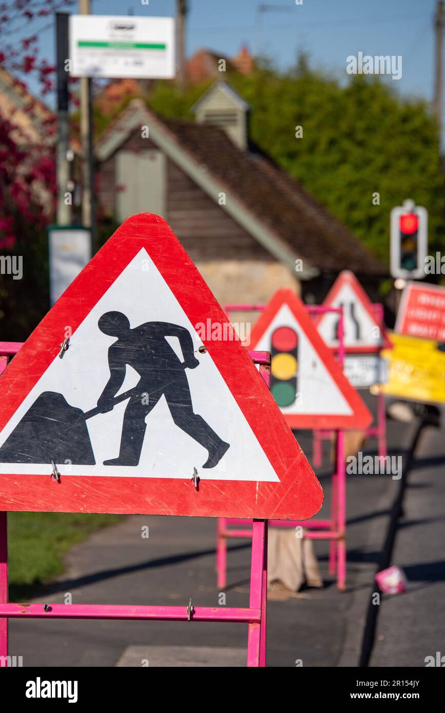Roadworks signs and temporary traffic lights Stock Photo - Alamy