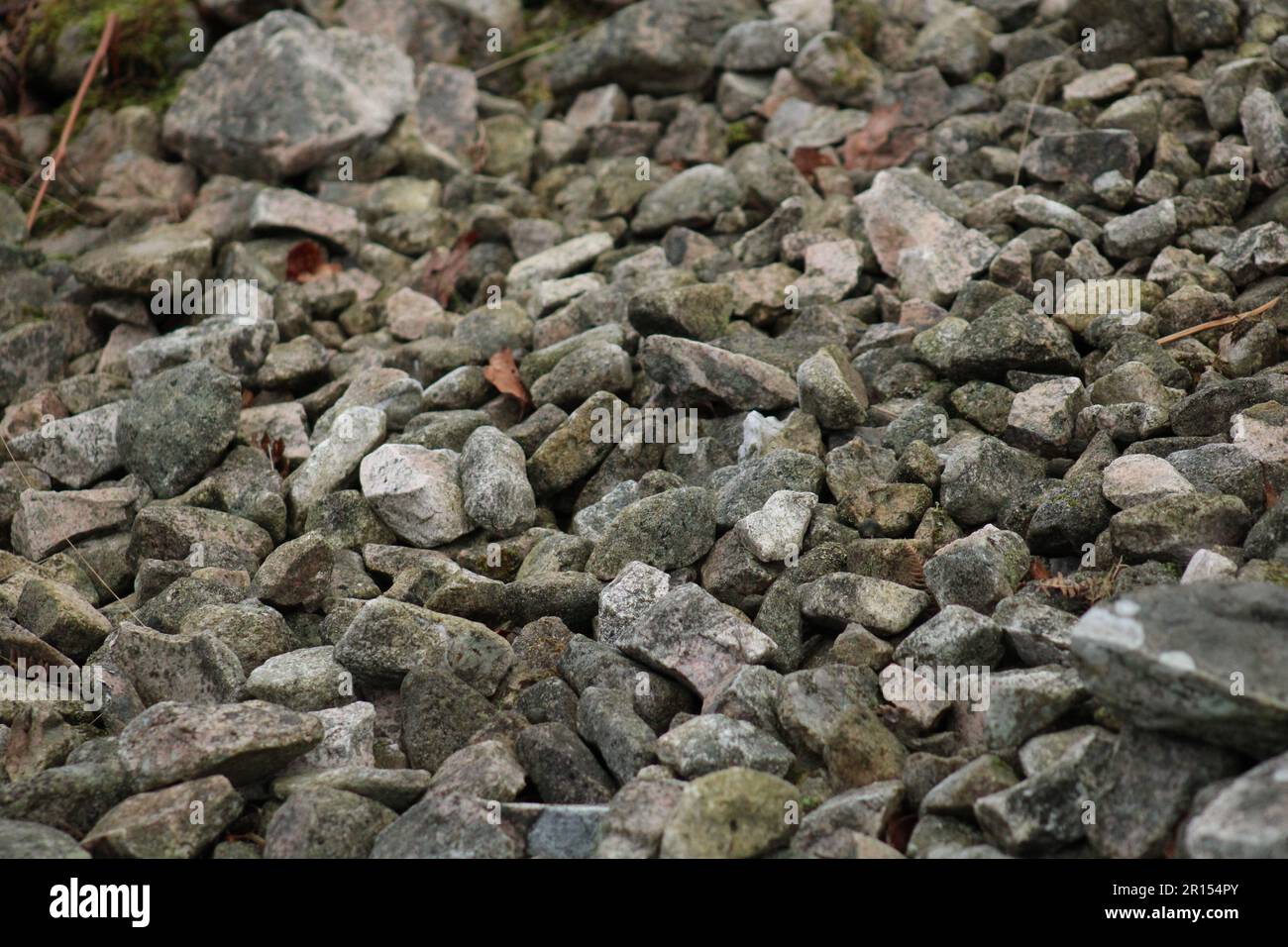 An outdoor landscape featuring a pile of natural rocks and gravel Stock ...