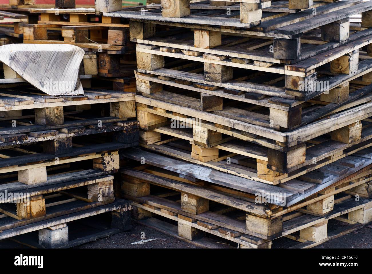 Old wooden pallets stacked on the ground. Industrial background Stock ...
