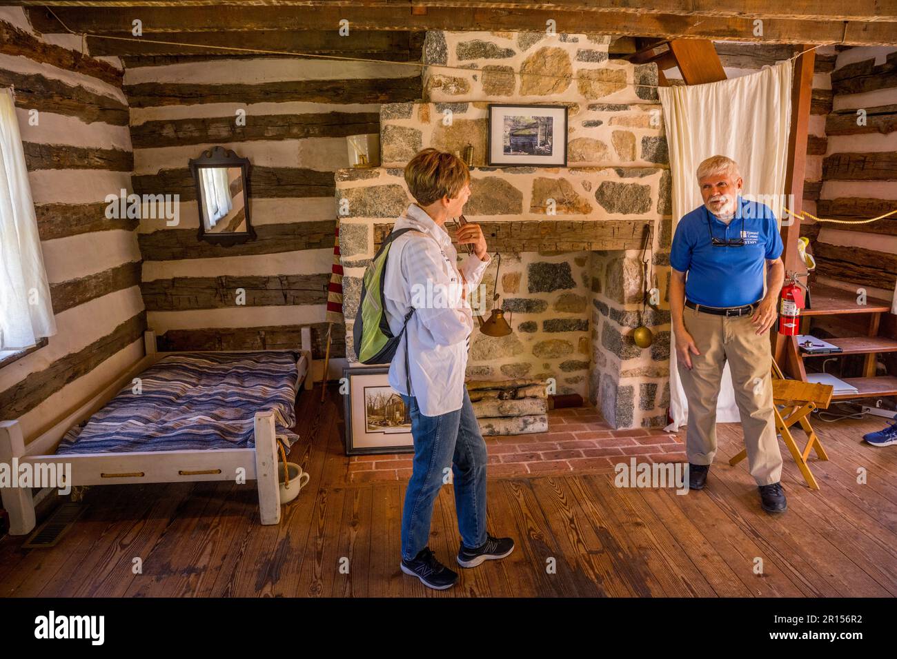 A volunteer explaining the interior of the historic Thomas Isaac log ...
