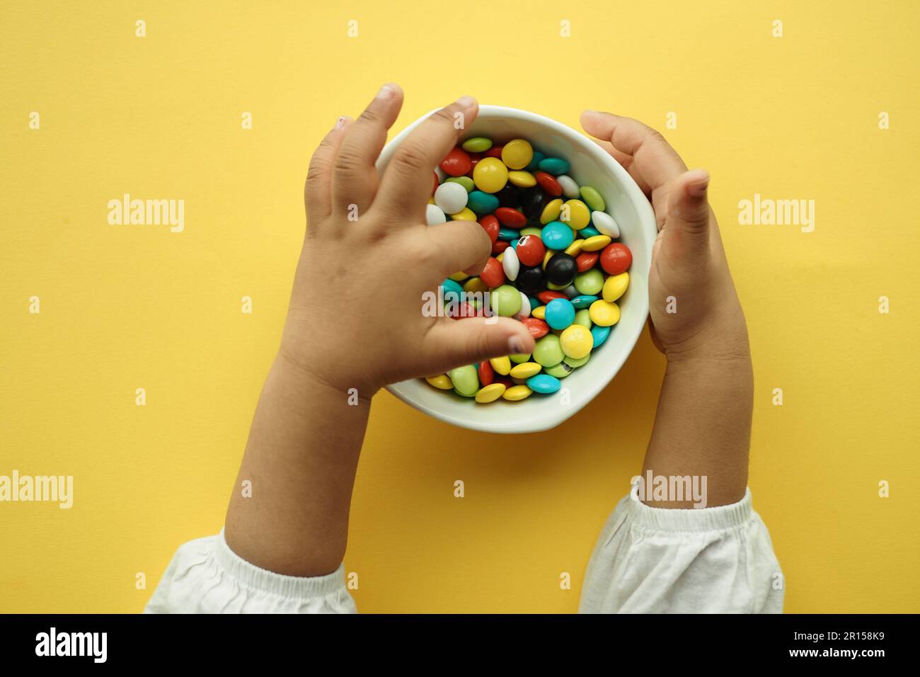 Child hand pick candy sweet hi-res stock photography and images - Alamy