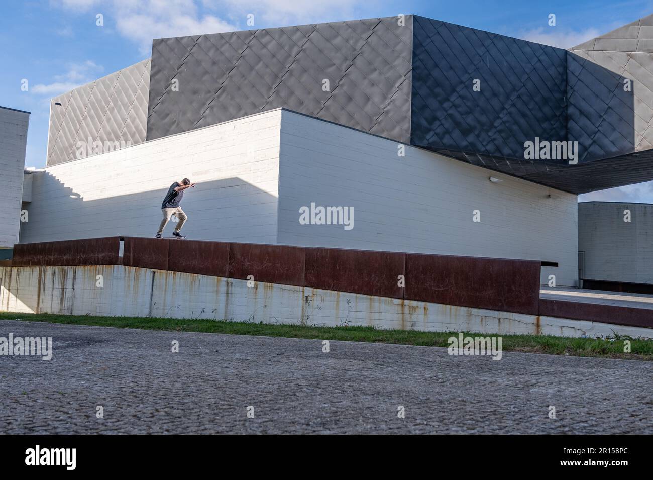 Skateboarder doing a nose slide trick on a urban scene Stock Photo - Alamy