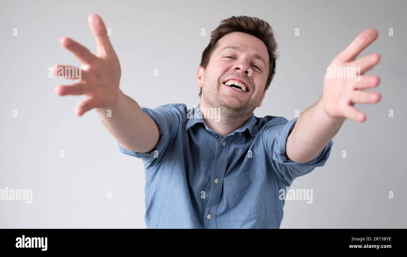 European young man is reaching out his hands forward to embrace the ...