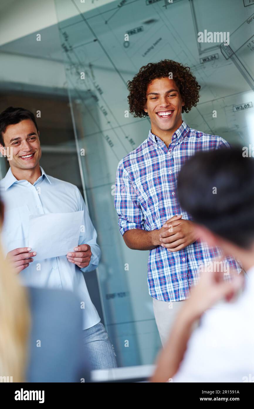 Getting positive feedback. Two attractive casual businessmen giving a ...