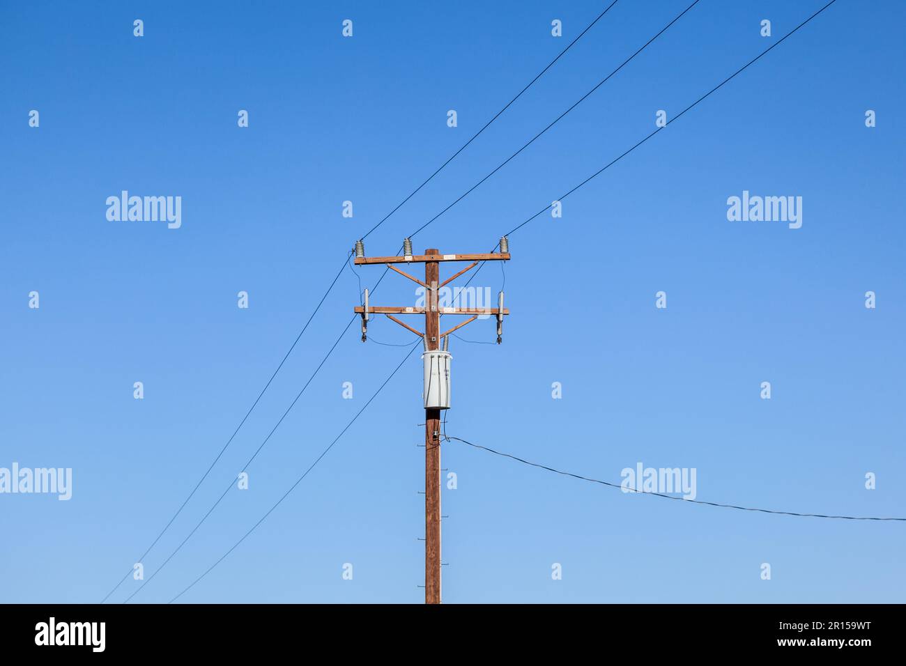electric pylon in the desert with wooden pile under blue sky Stock ...