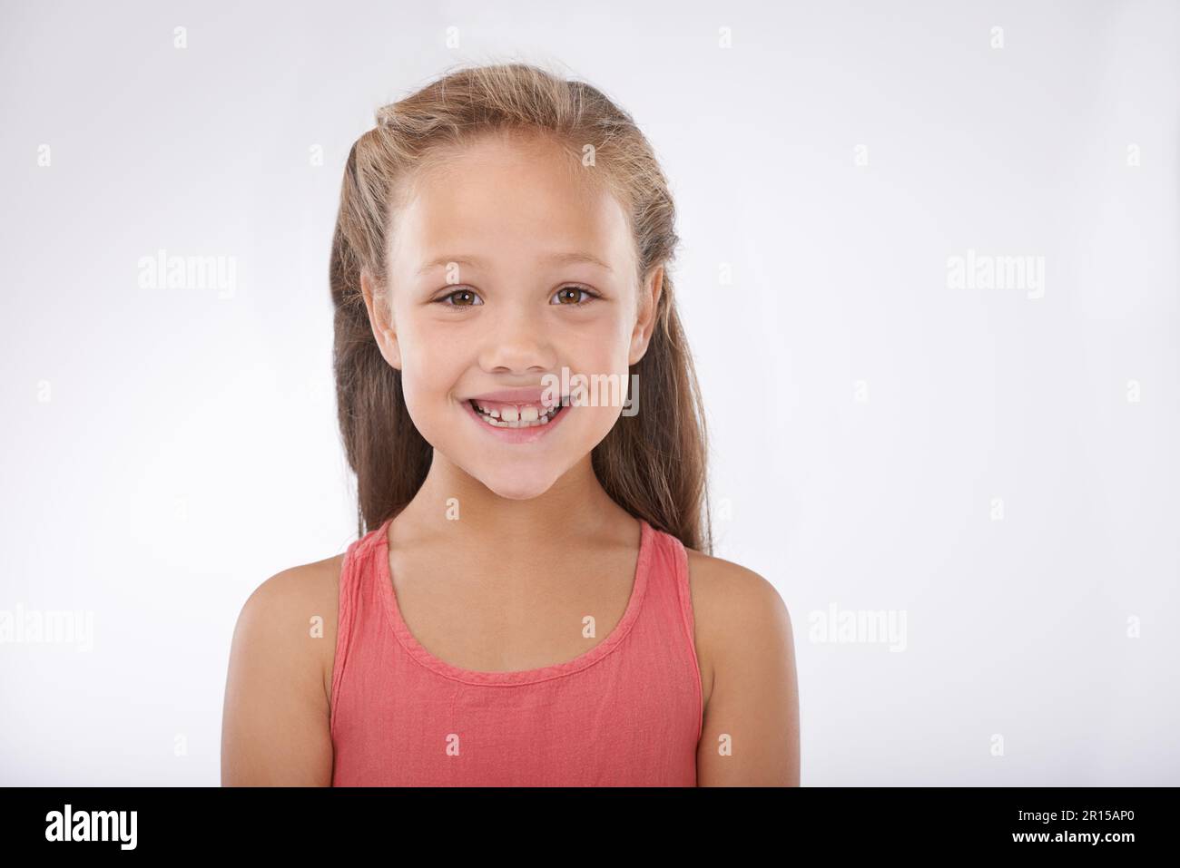 What a cutie. Studio portrait of an adorable young girl smiling at the ...