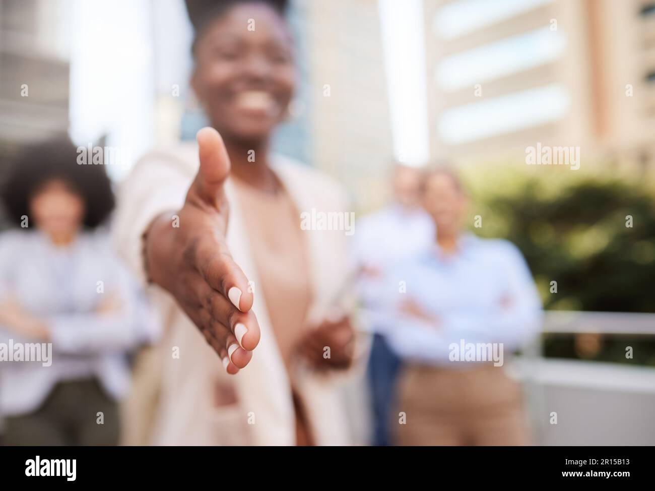 Shall we shake on it. an unrecognisable businesswoman standing with her ...