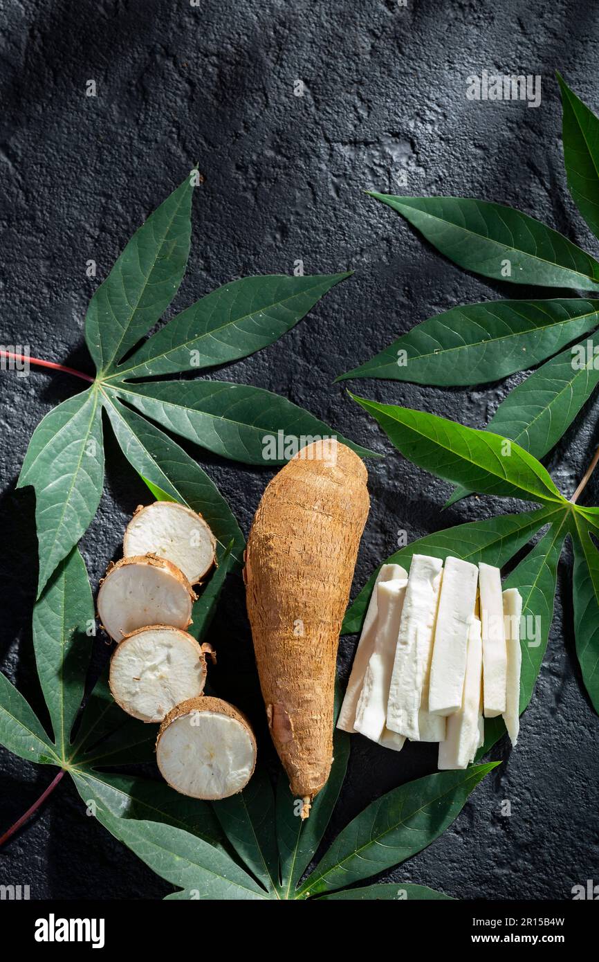pile of cassava fruit and cassava flour on a background of rustic and ...