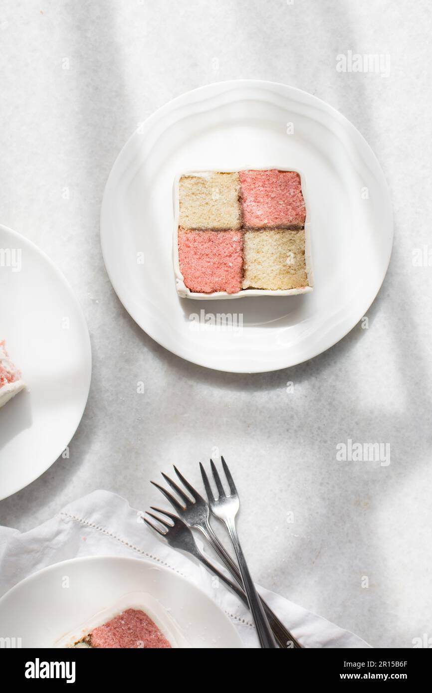 Top view of battenburg cake slice in a white plate, almond and ...