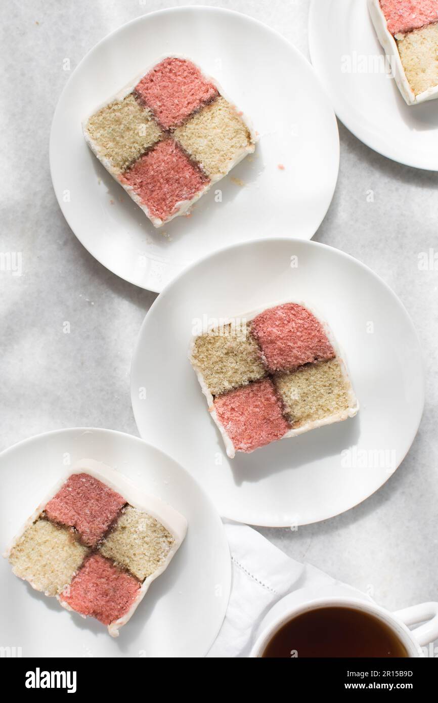 Top view of battenburg cake slice in a white plate, almond and ...