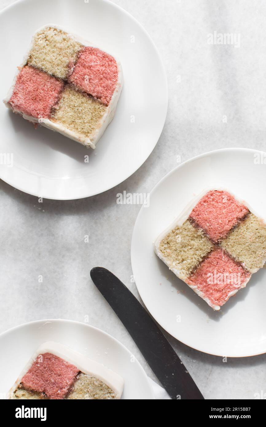 Top view of battenburg cake slice in a white plate, almond and ...