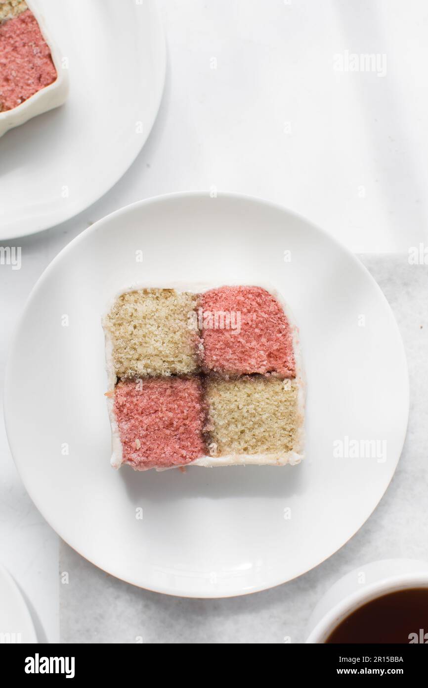 Top view of battenburg cake slice in a white plate, almond and ...