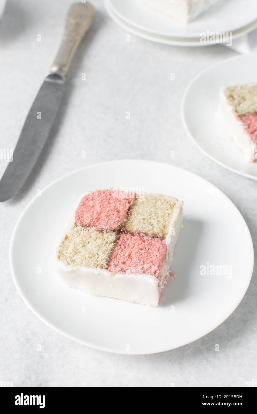 Top view of battenburg cake slice in a white plate, almond and ...