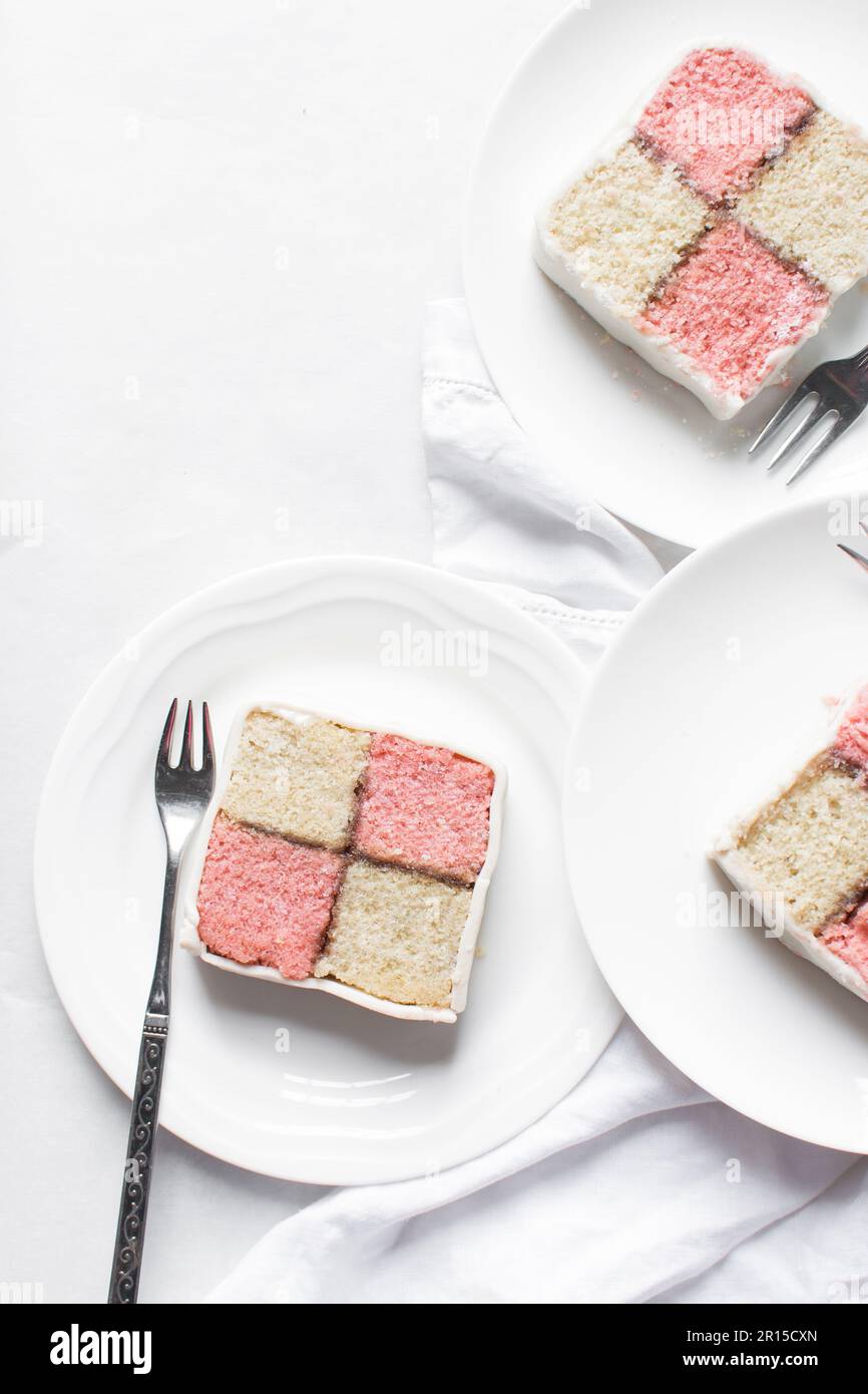 Top view of battenburg cake slice in a white plate, almond and ...
