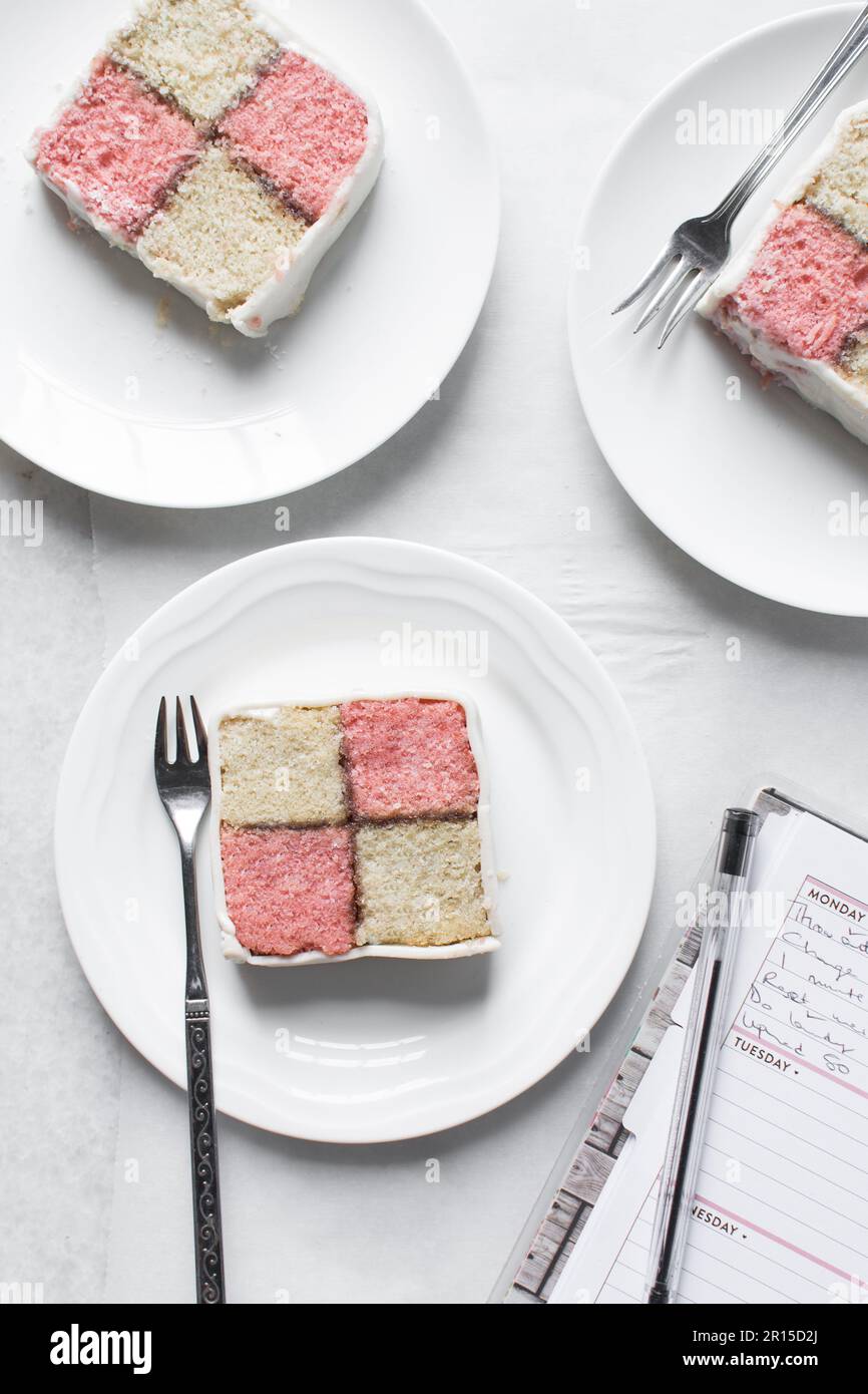 Top view of battenburg cake slice in a white plate, almond and ...