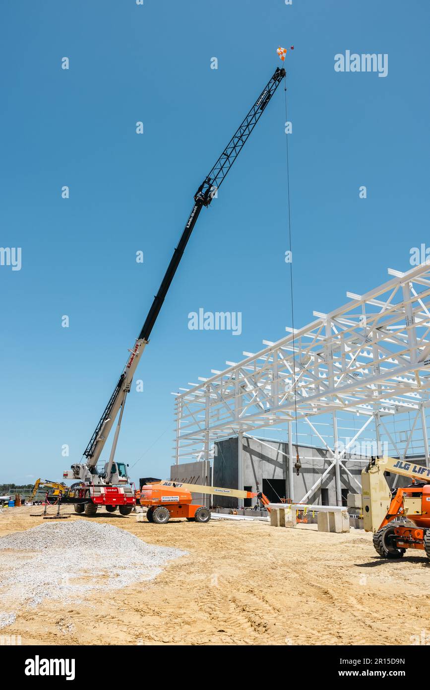 A crane is parked next to the final beam during a topping out ceremony ...