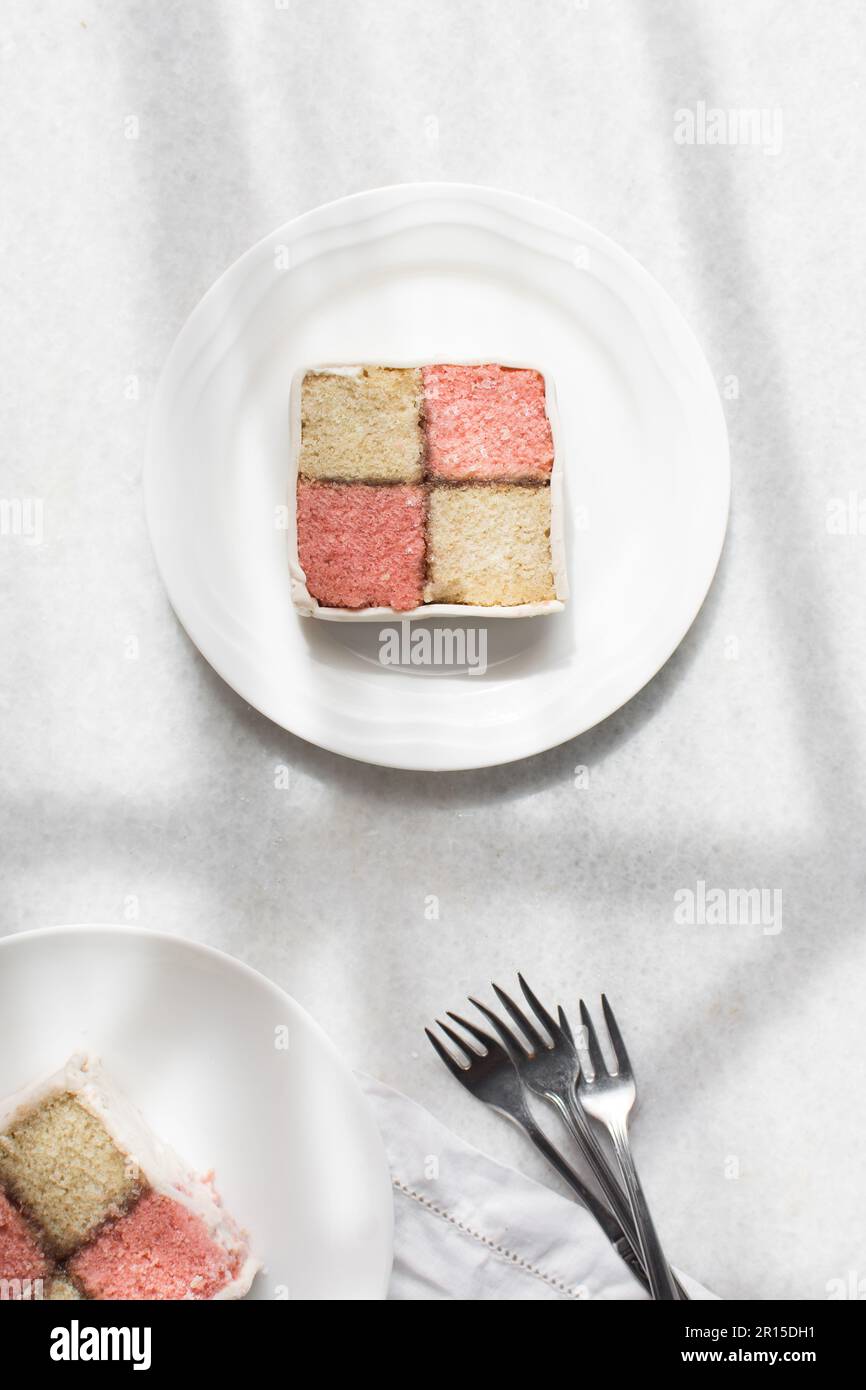 Top view of battenburg cake slice in a white plate, almond and ...