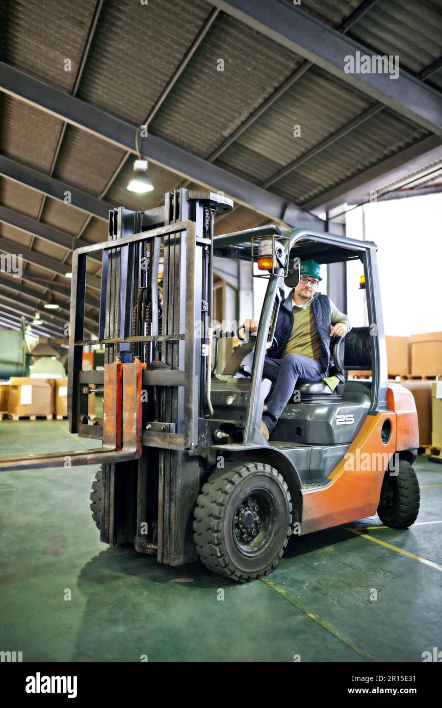 Rolling around the factory. a forklift driver in a warehouse Stock ...