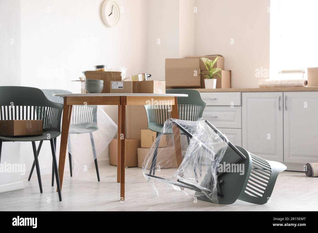 Dining table with cardboard boxes in kitchen on moving day Stock Photo ...
