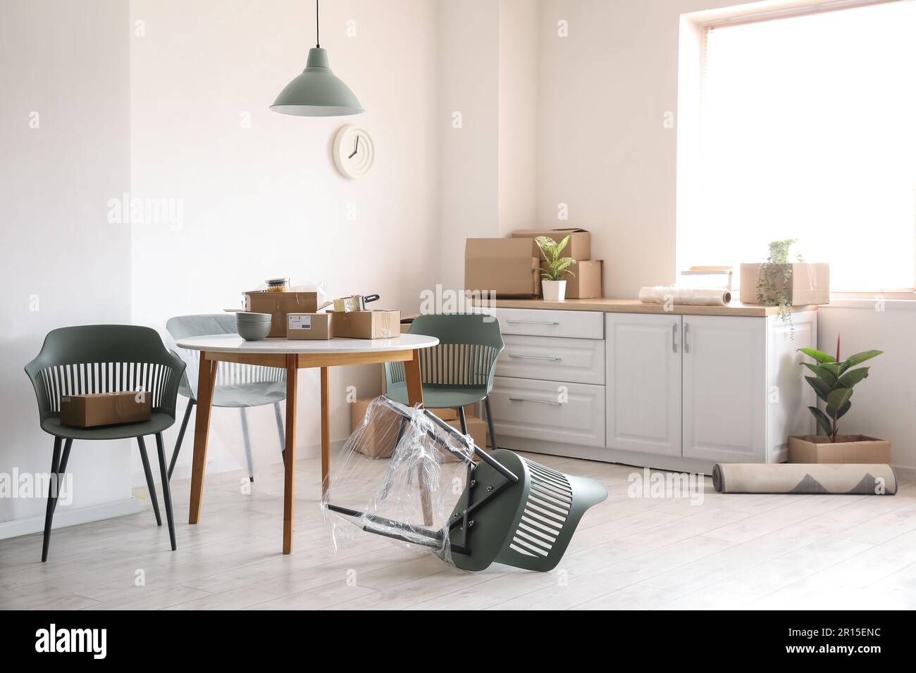 Dining table with cardboard boxes in kitchen on moving day Stock Photo ...