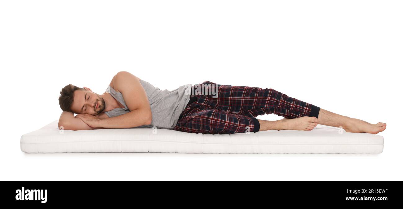 Man sleeping on soft mattress against white background Stock Photo - Alamy