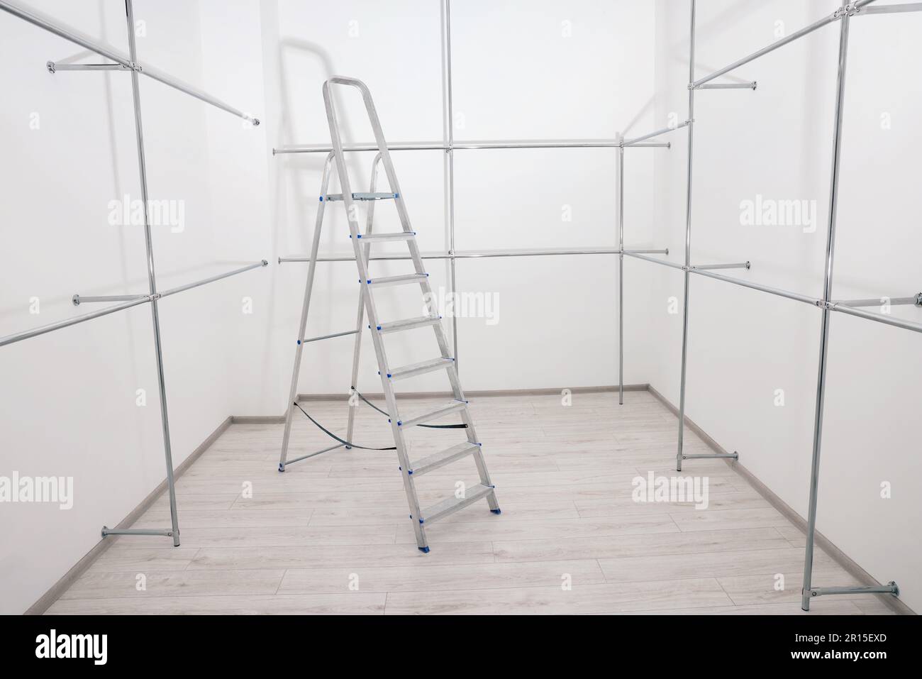 Ladder and metal pipes in empty renovated room Stock Photo - Alamy