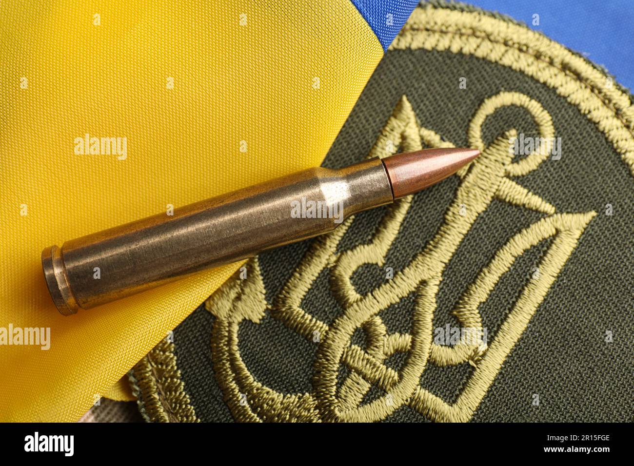 Bullet and military patch on Ukrainian flag, top view Stock Photo - Alamy