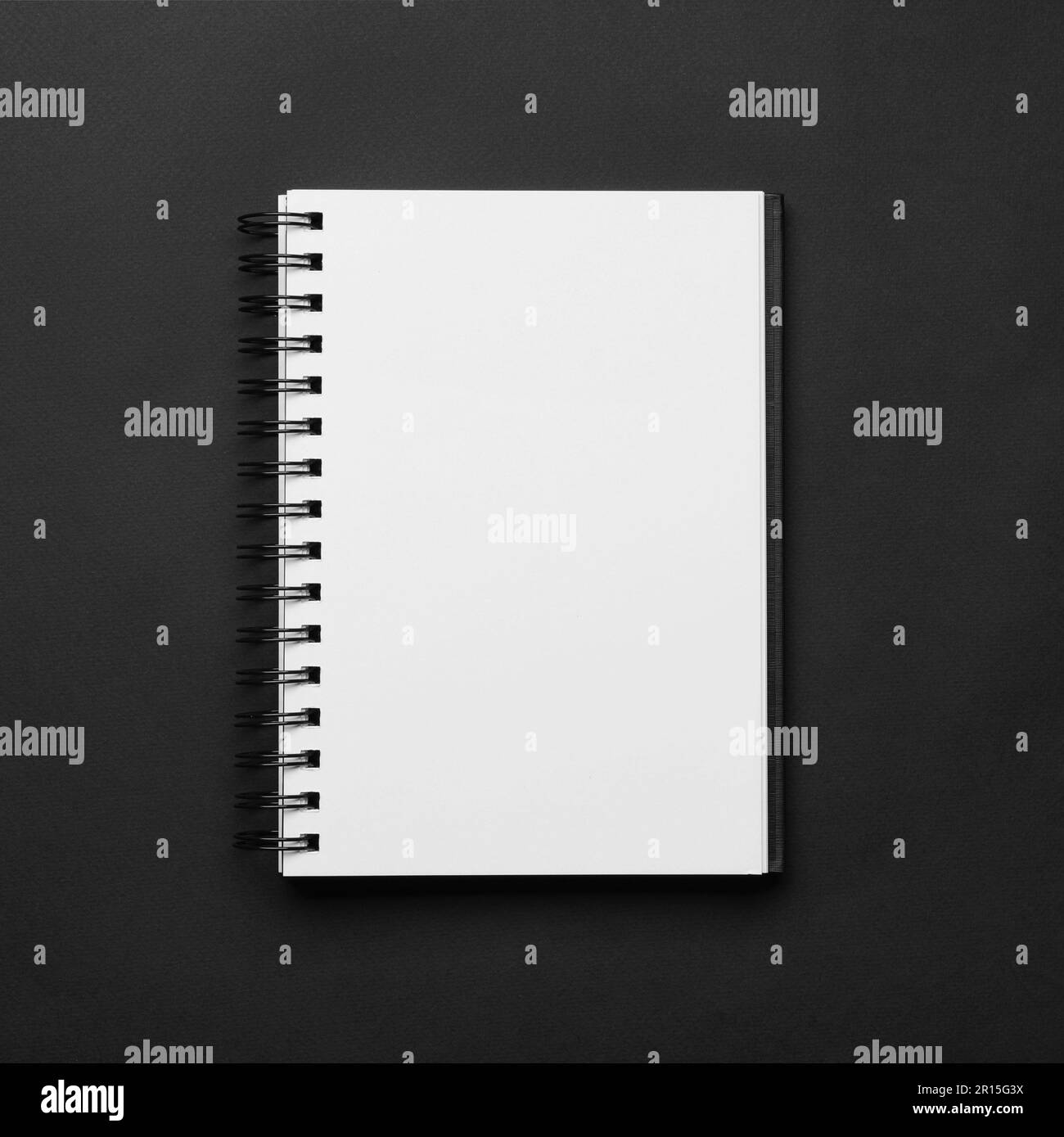Spiral bound notebook on black background, top view Stock Photo - Alamy