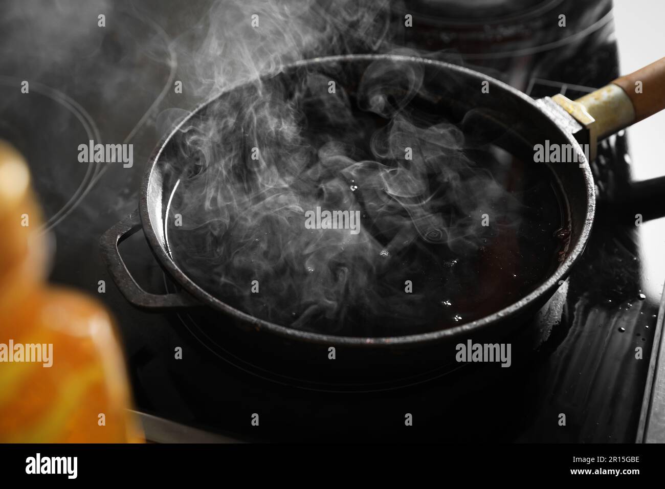 Frying pan with hot used cooking oil on stove Stock Photo - Alamy