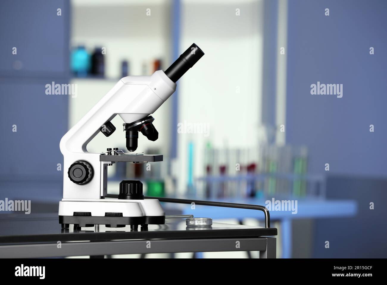 Modern medical microscope on metal table in laboratory, space for text ...