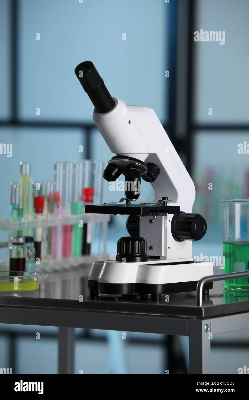 Modern microscope with glass slide on metal table in laboratory Stock ...