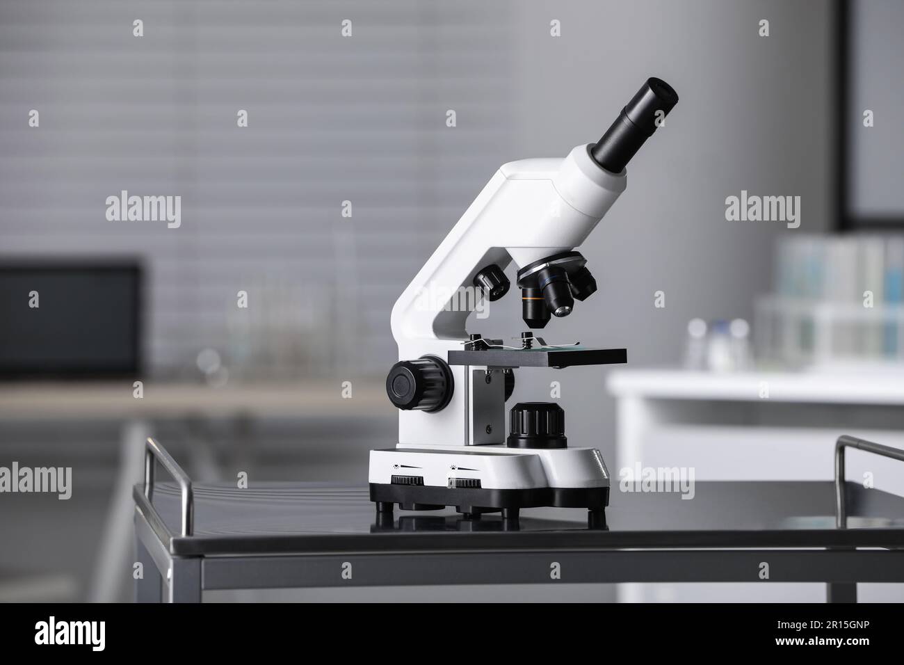 Modern medical microscope on metal table in laboratory Stock Photo - Alamy